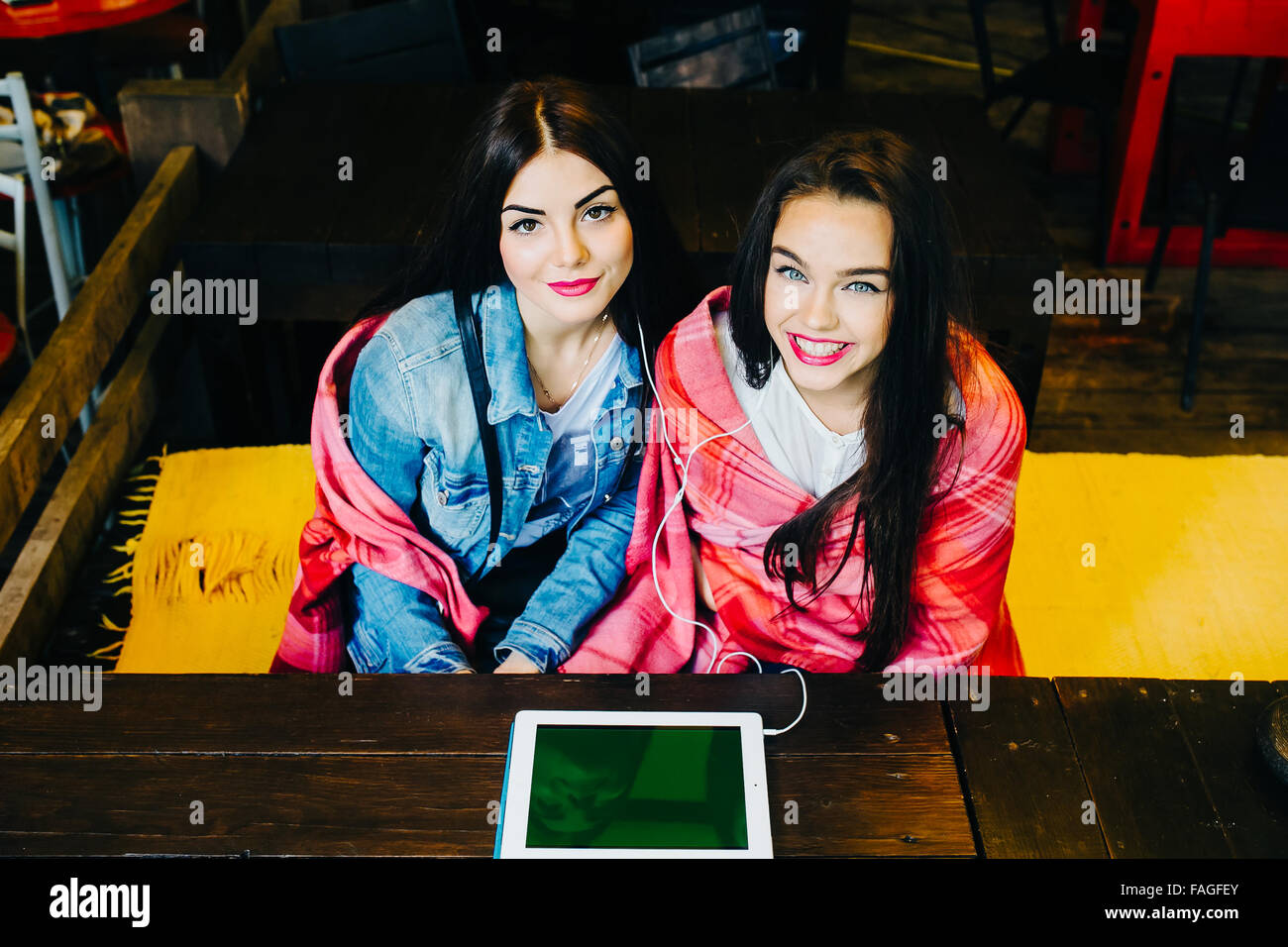 two close friends watching something on a tablet Stock Photo - Alamy