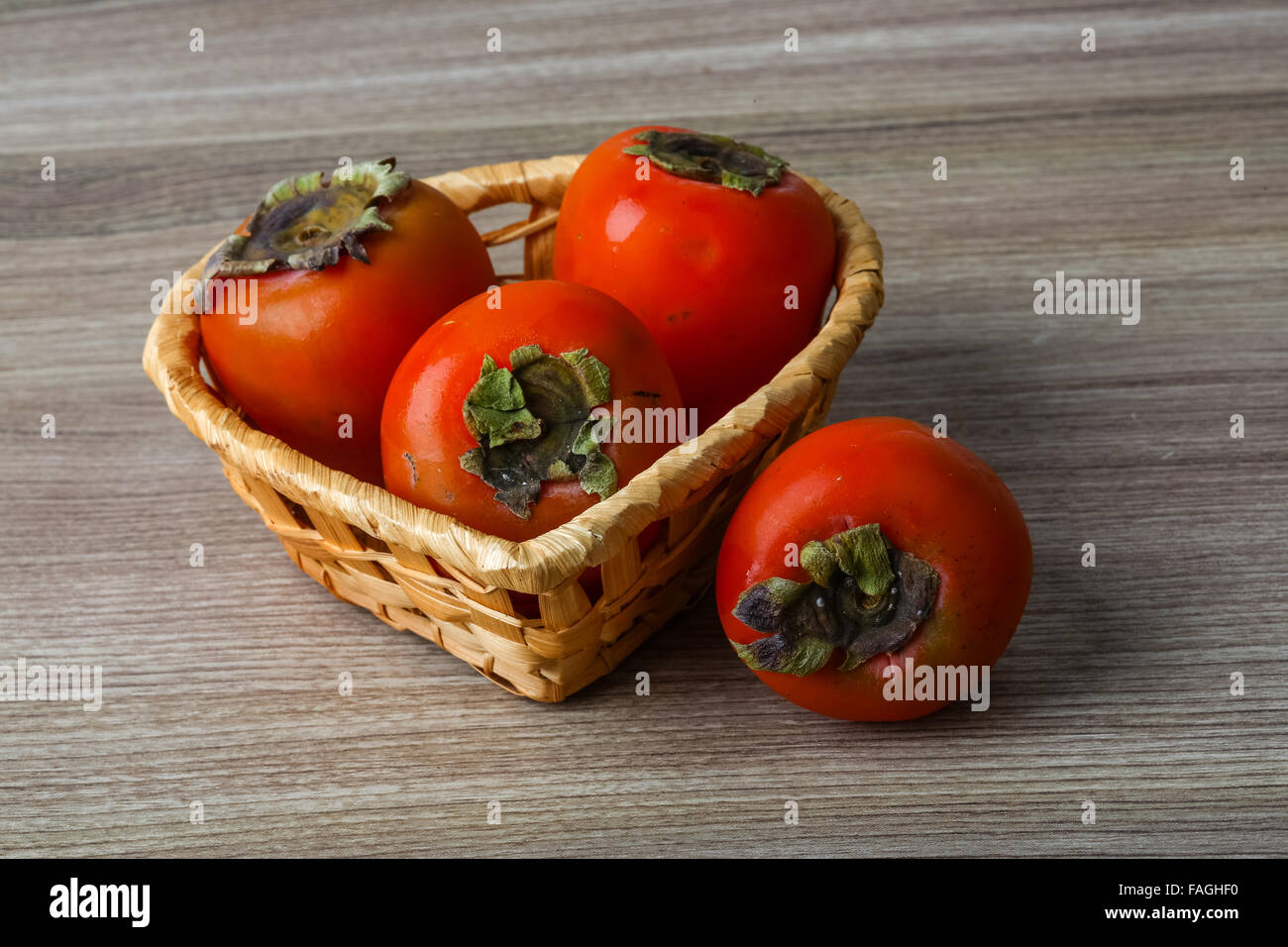 Fresh ripe juicy Persimmon fruit on the wood background Stock Photo - Alamy