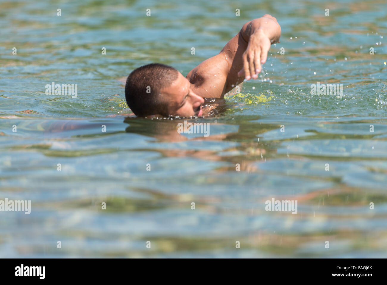 Young Man Swimming In Lake Green Water Stock Photo - Alamy