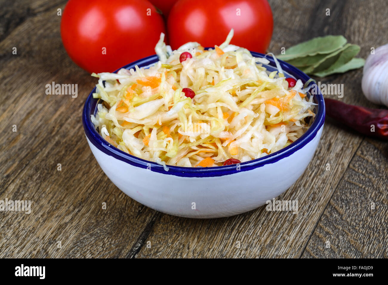 Fermented cabbage - Sauerkraut with herbs and spices on the wood ...