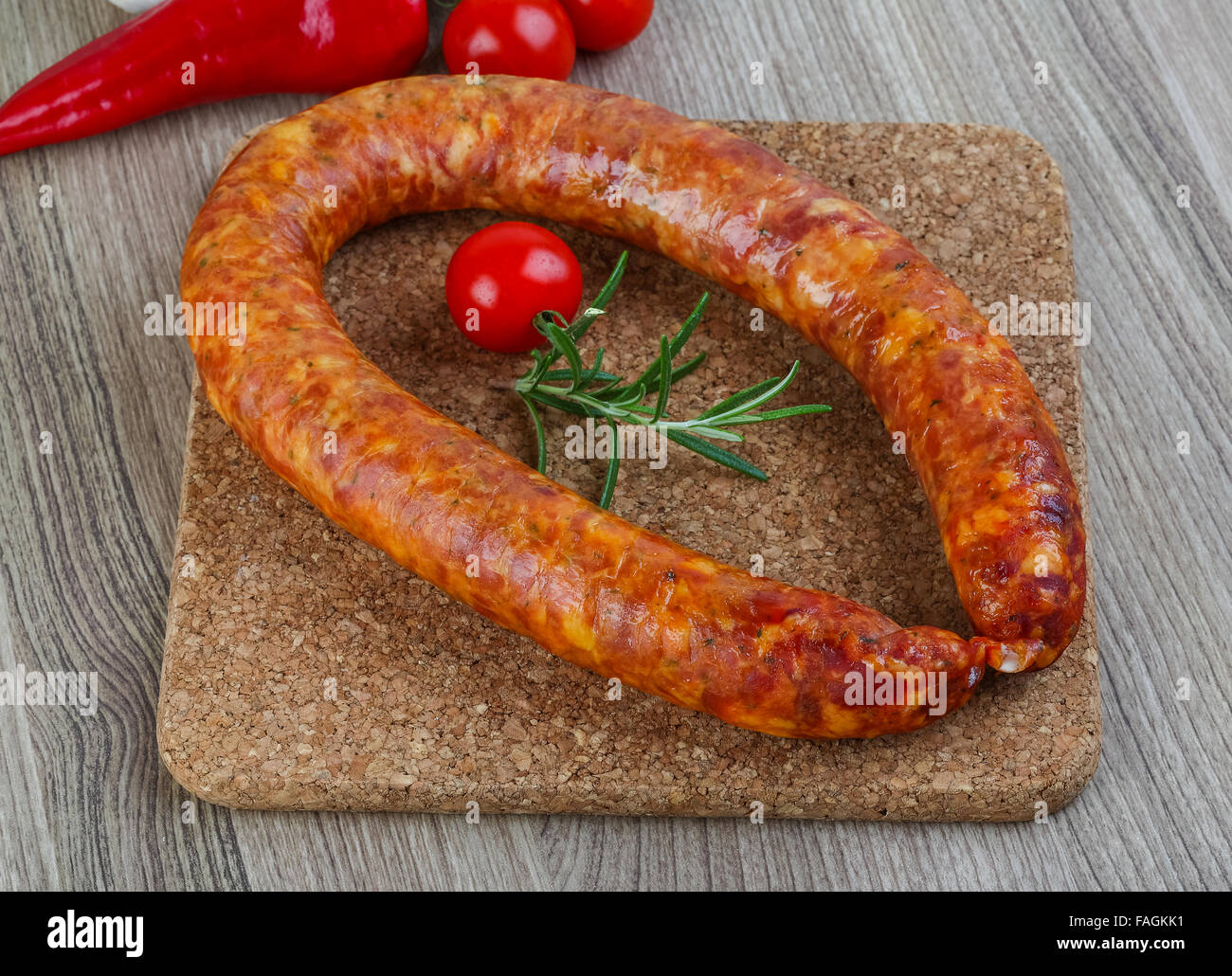 Sausage ring with rosemary and pepper on the wood background Stock ...
