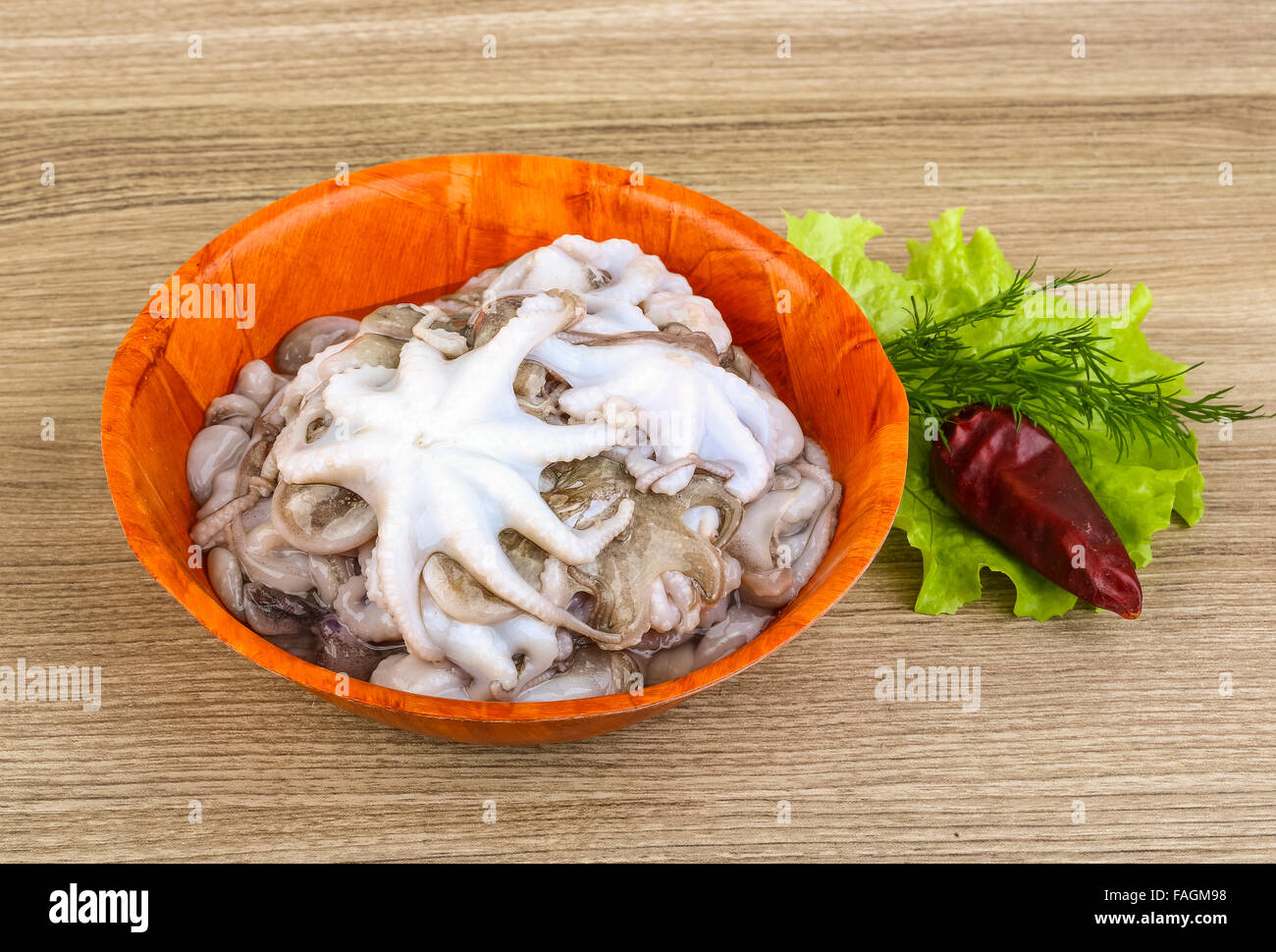 Raw baby octopus in the bowl ready for cooking Stock Photo - Alamy