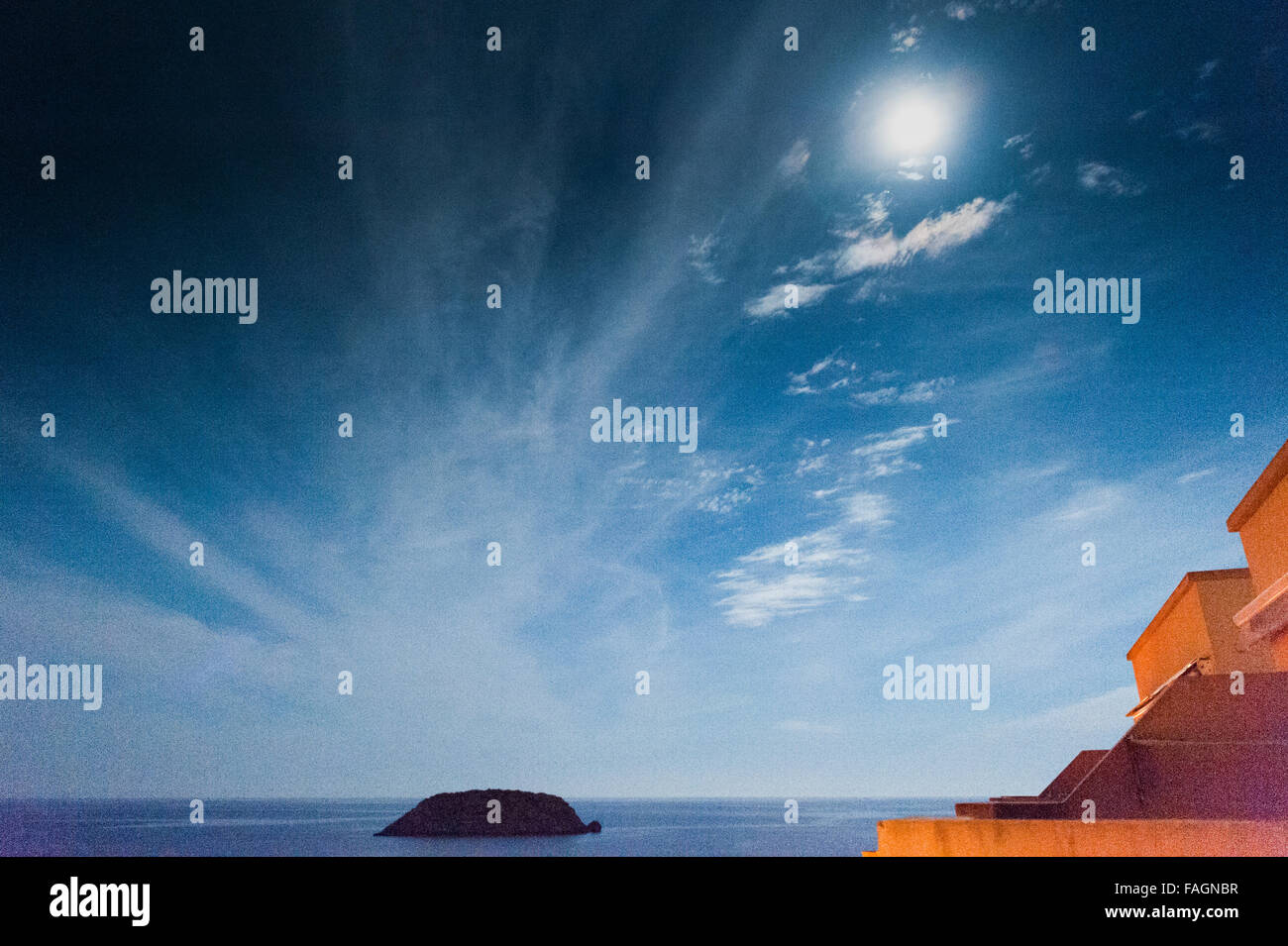 Moon rise over the calm beautiful water in Es Canar, Ibiza, part of the ...