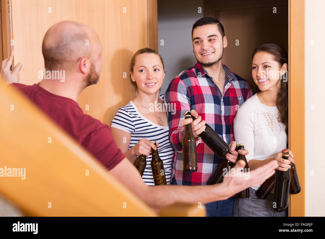 Cheerful friends gathering together at house booze party Stock Photo ...