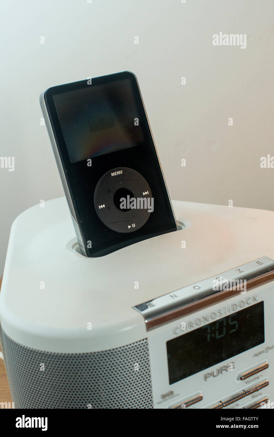 iPod charging in a bedside alarm clock dock Stock Photo - Alamy