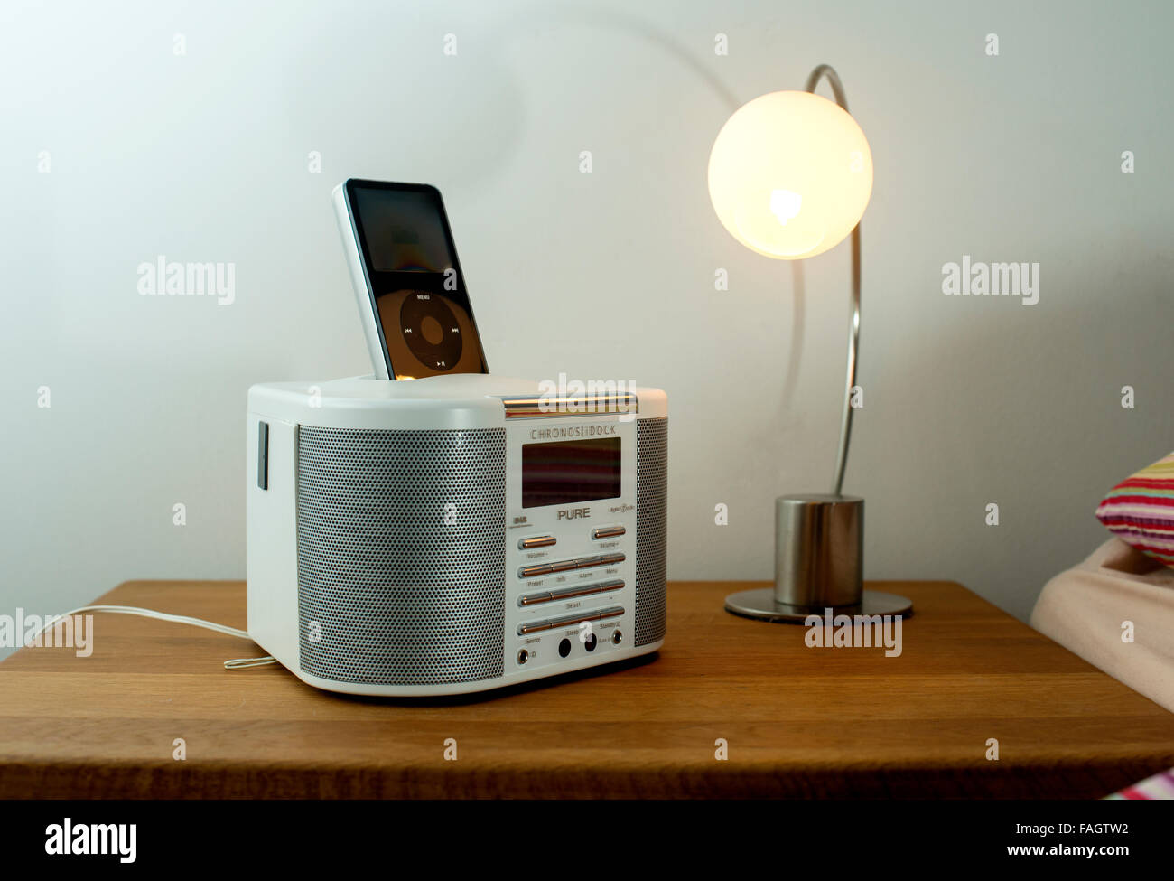 iPod charging in a bedside alarm clock dock Stock Photo - Alamy