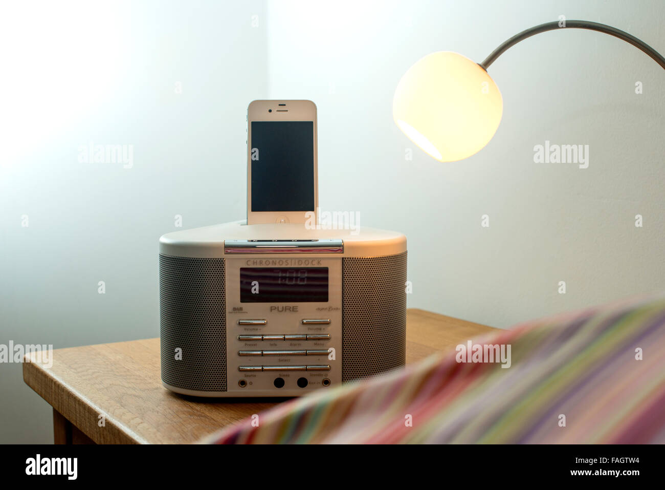 iPhone 4S charging in a bedside alarm clock dock Stock Photo - Alamy