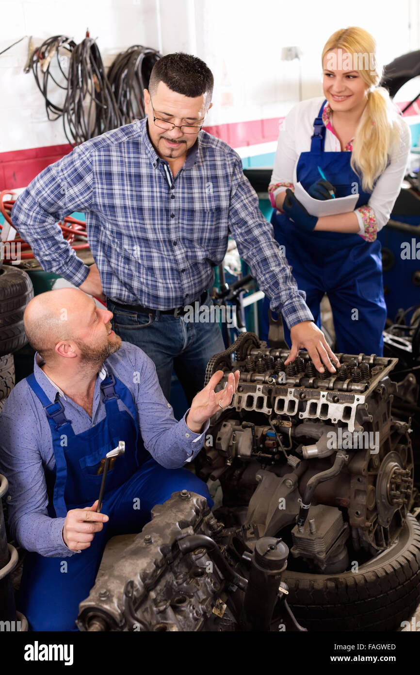 Service crew and friendly client standing near car Stock Photo - Alamy