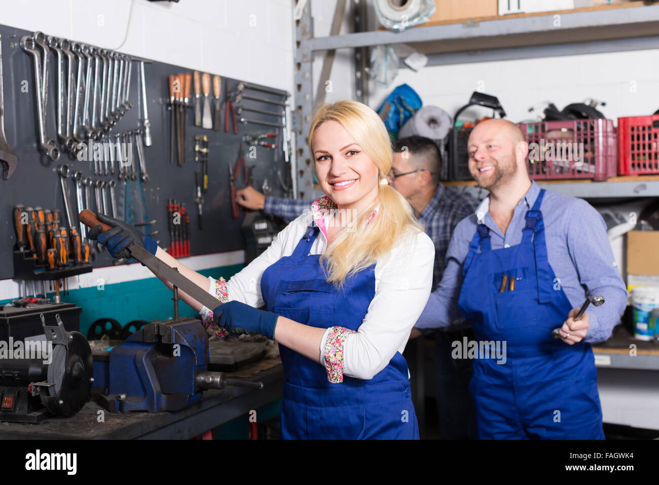 Portrait of auto service center crew near tools and equipment. Focus on ...
