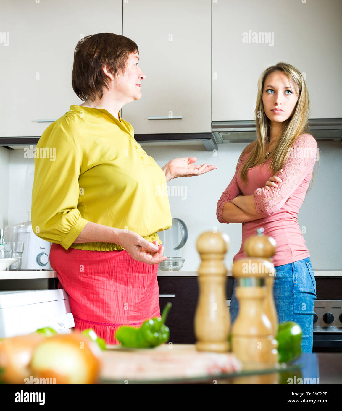 Mature mother arguing in the kitchen with her adult daughter Stock ...