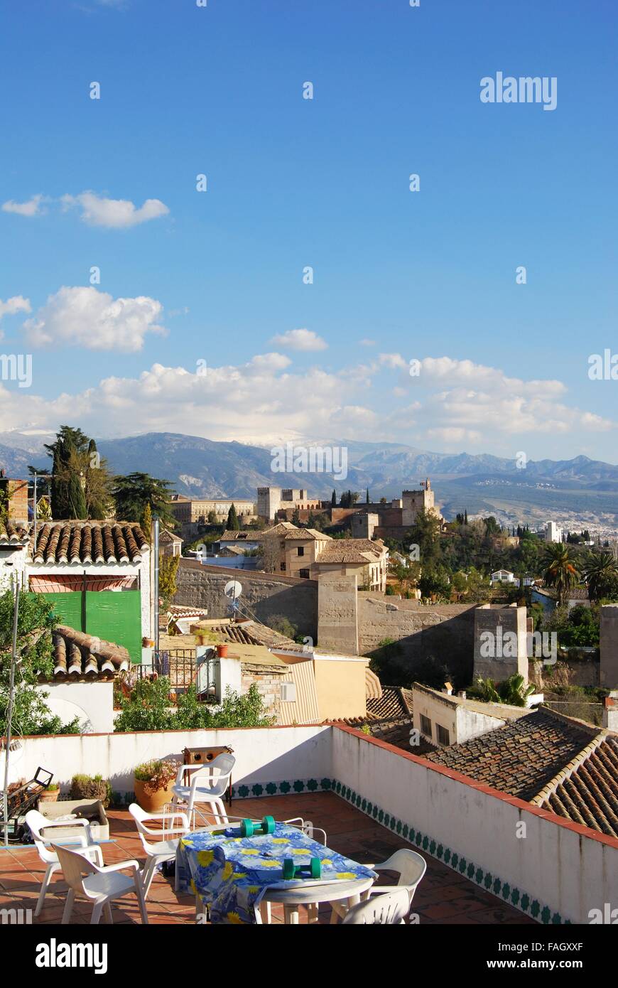 View of the Palace of Alhambra with snow capped mountains of the Sierra ...