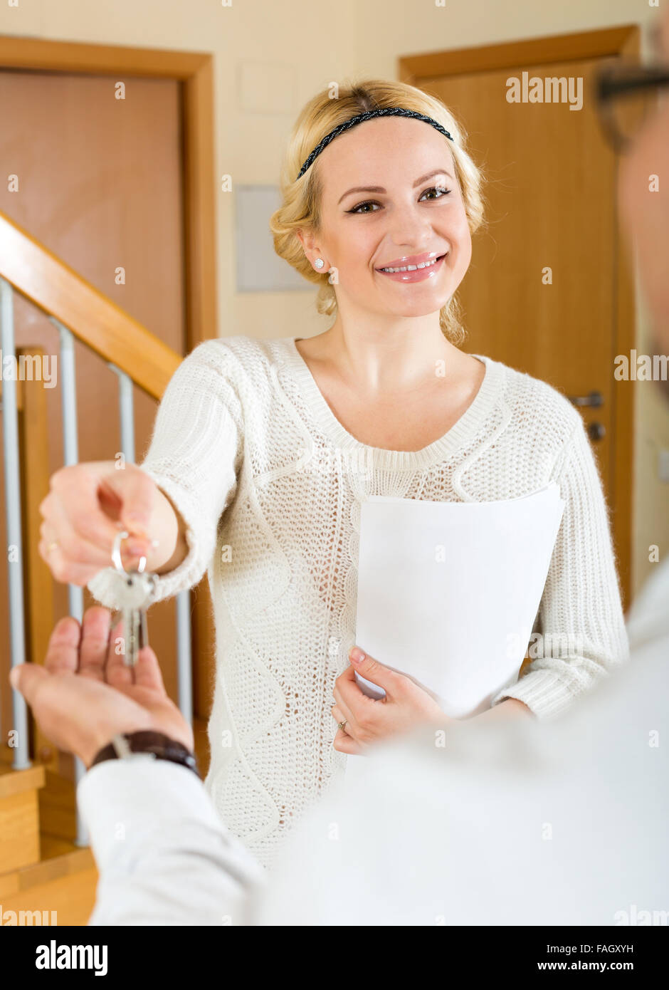 Young agent giving to man client keys from flat and papers Stock Photo ...