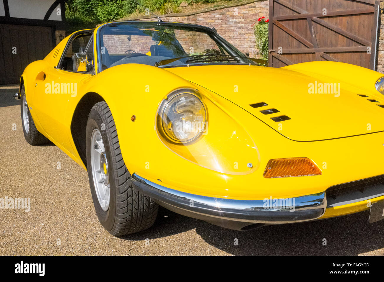 A classic bright yellow ferrari dino 246 GTS targa top shot from the ...