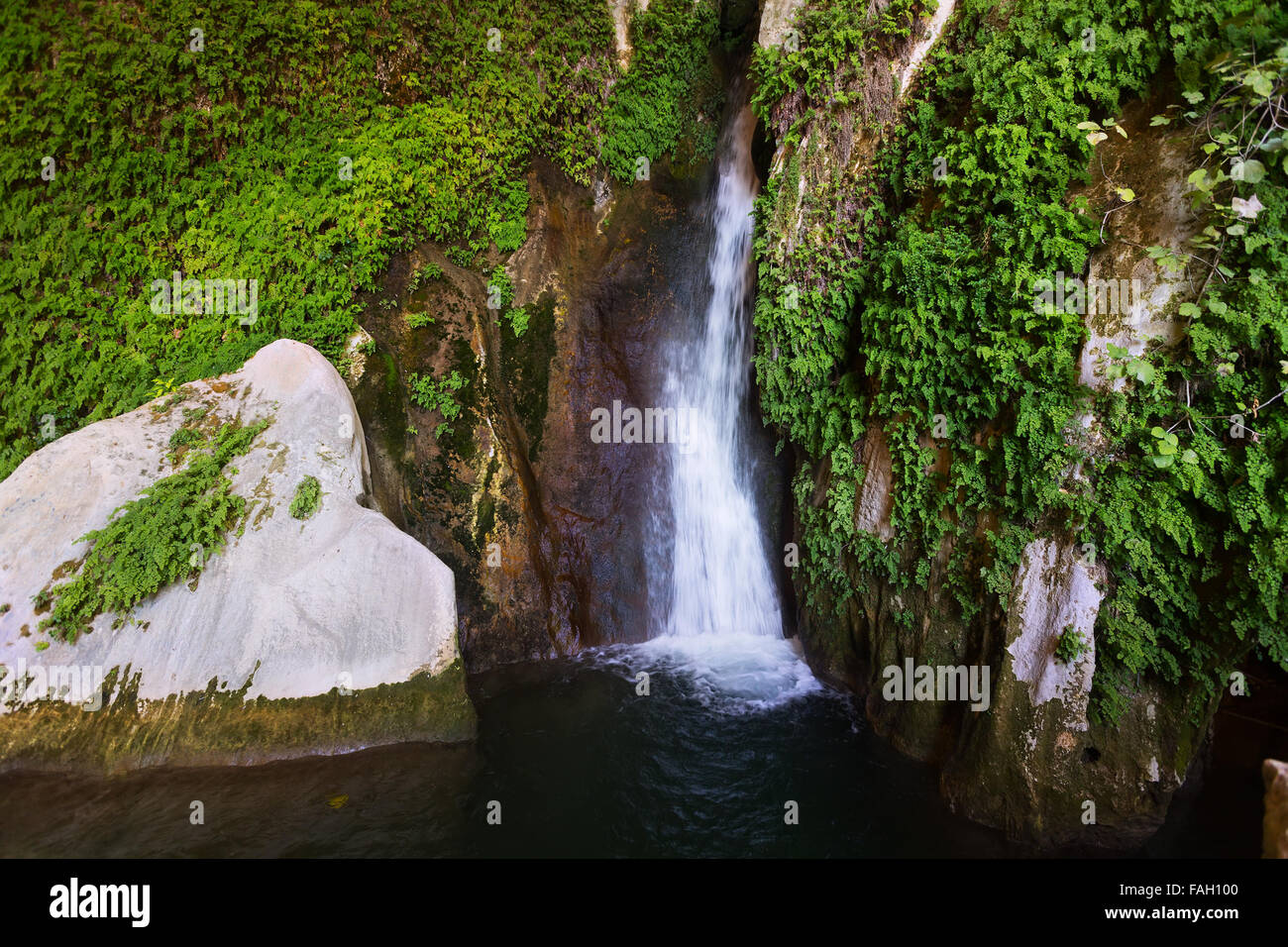 Waterfall in rocky grot at mountains Stock Photo - Alamy