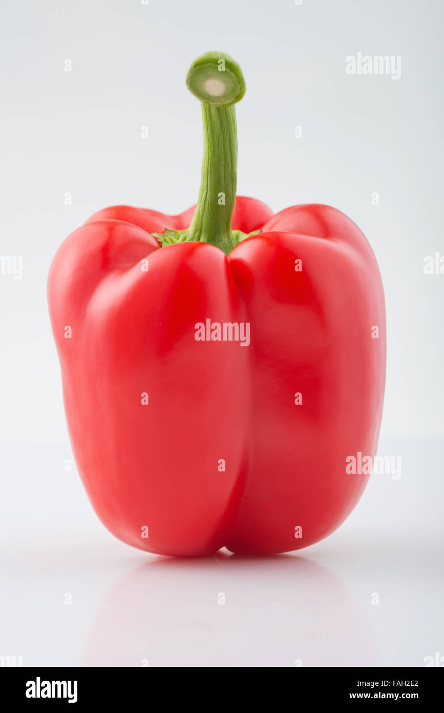 Big red pepper is on white surface Stock Photo - Alamy