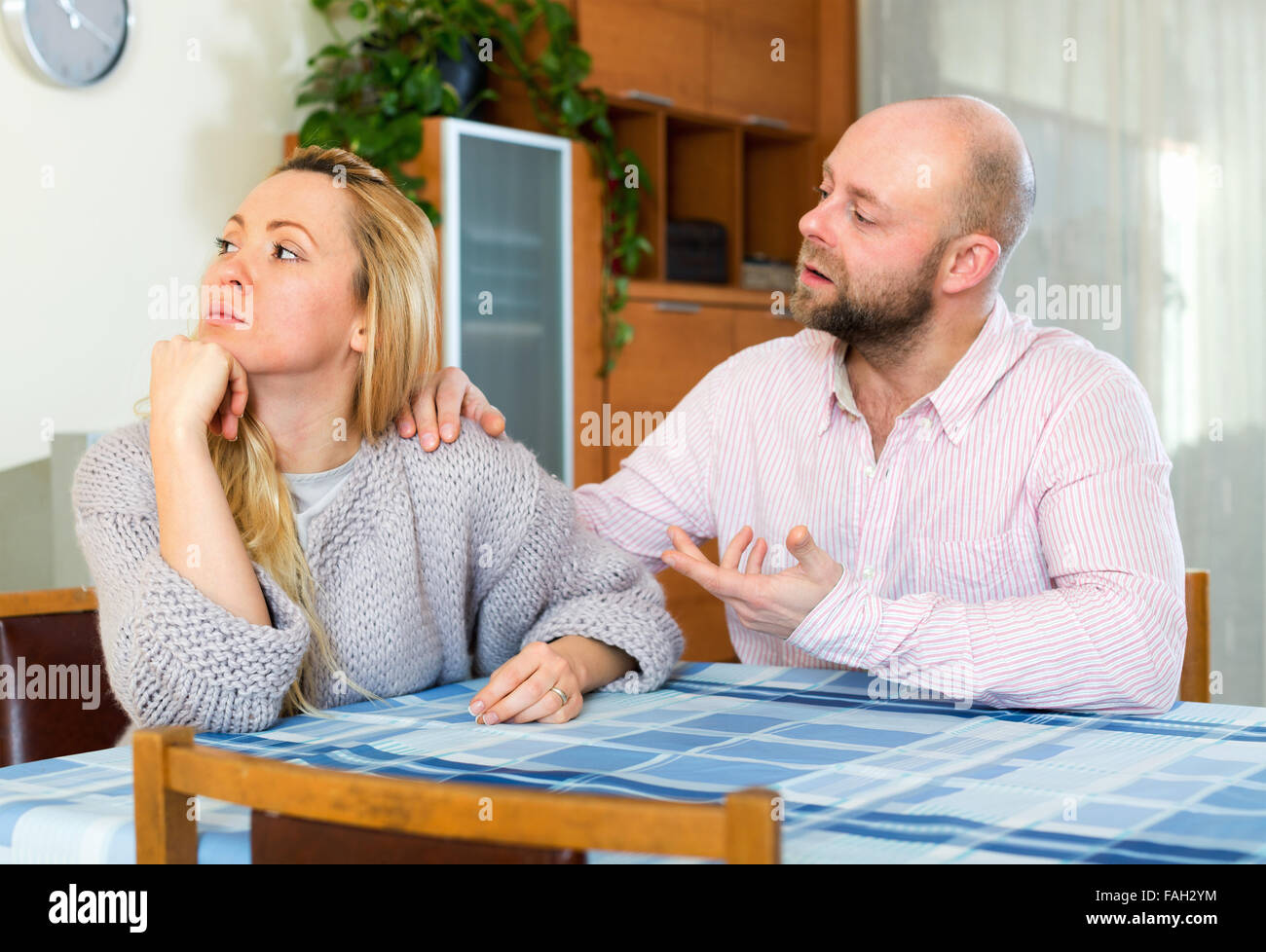 Man asking for forgiveness from sad woman at home Stock Photo - Alamy