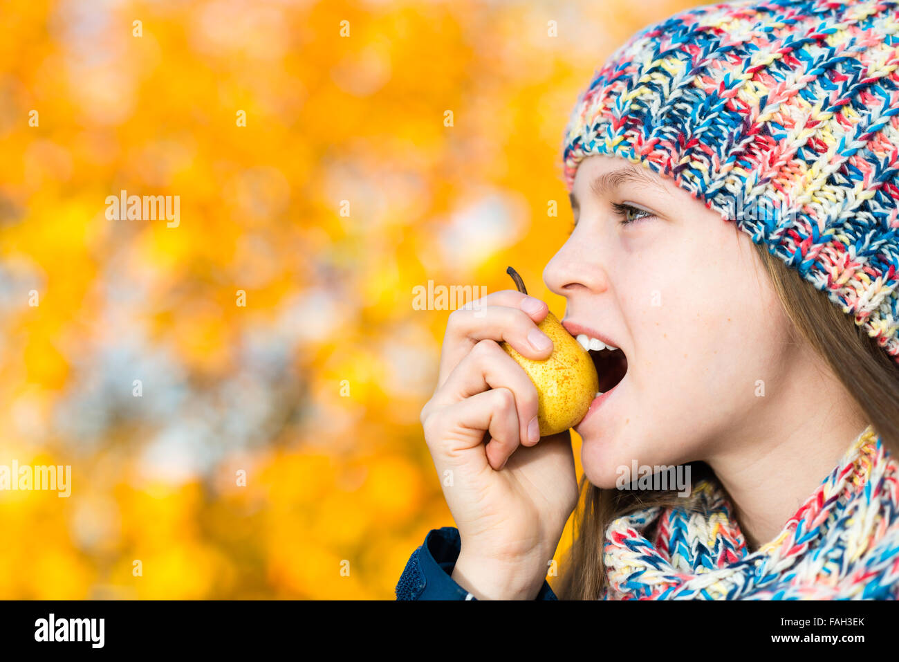 Girl Eating Pear - autumnal background Stock Photo - Alamy