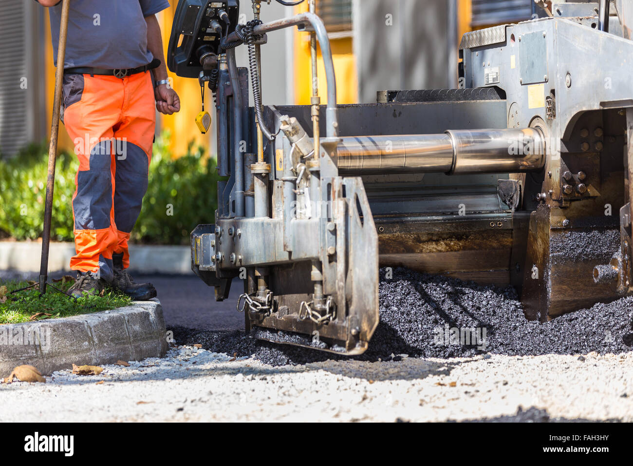 Asphalt surfacing manual labor Stock Photo - Alamy