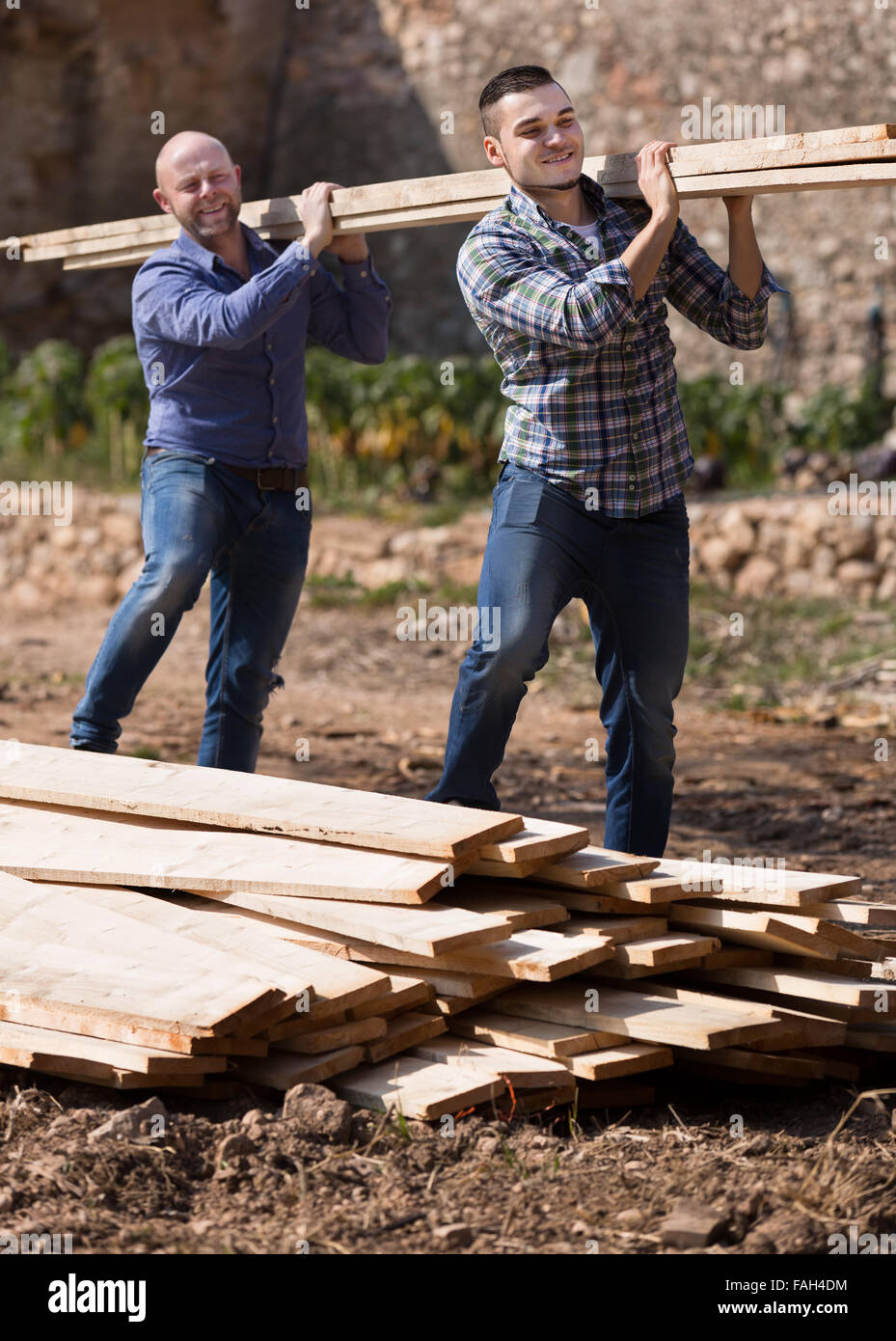 Two smiling farmers working with construction materials outdoors Stock ...