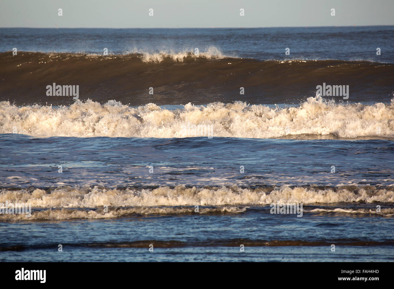North Sea waves at Tynemouth in England. The waves break as they roll ...