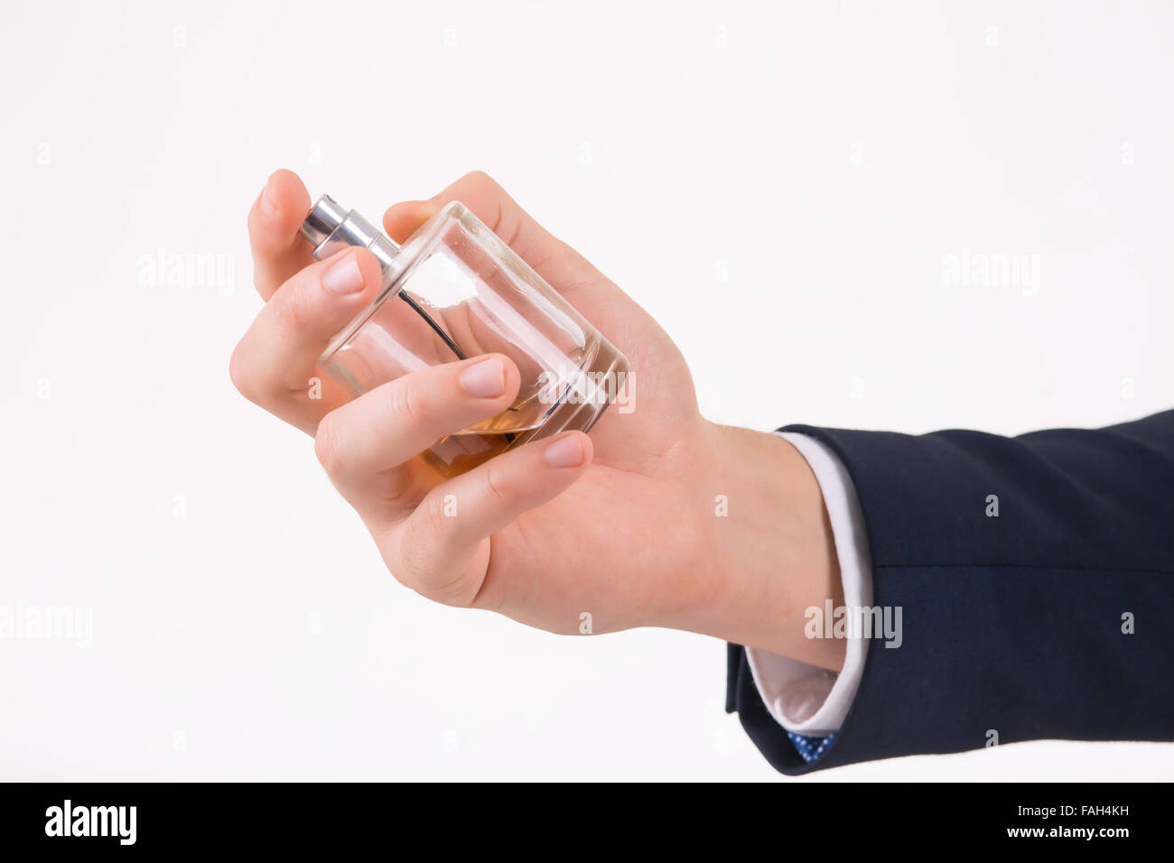 Male hand holding a perfume Stock Photo - Alamy