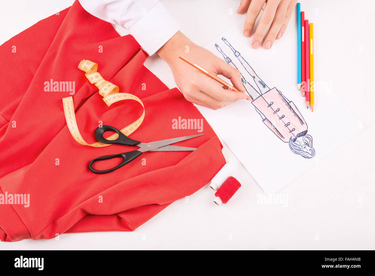 Dressmaker drawing an outfit sketch Stock Photo - Alamy