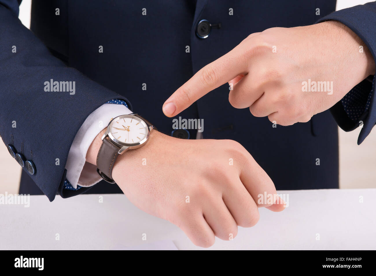 Man pointing at the wristwatch Stock Photo - Alamy
