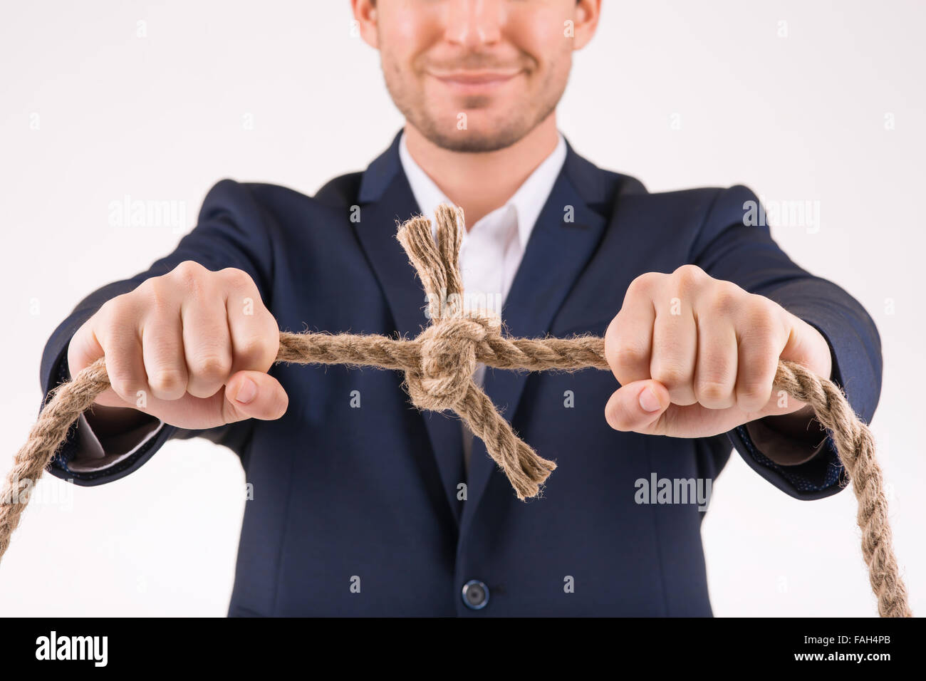 Man upholding knotted rope Stock Photo - Alamy