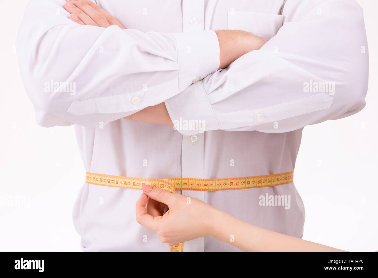 Person is being measured by measuring tape Stock Photo - Alamy
