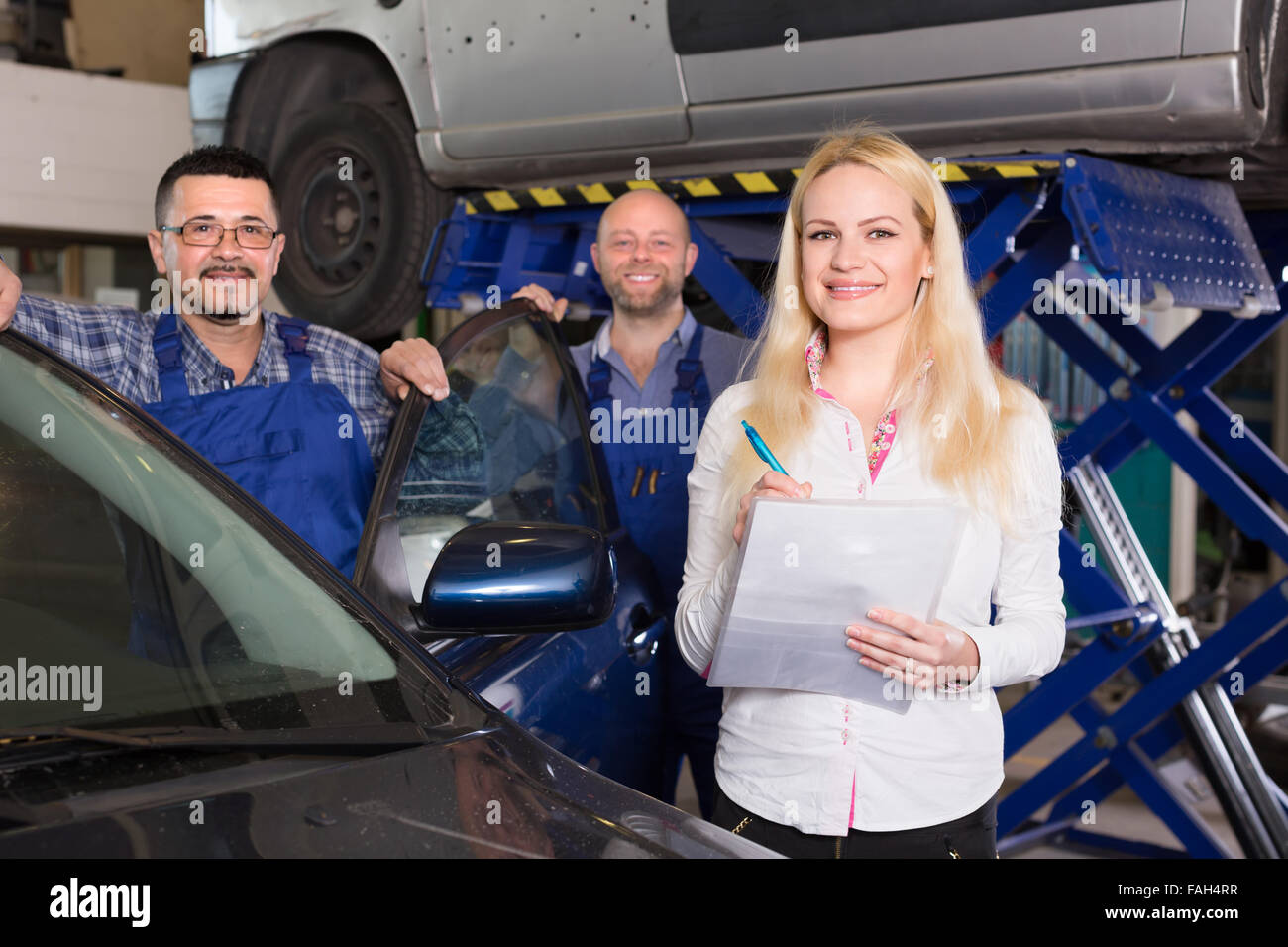 Attractive smiling female insurance agent discussing with positive auto ...