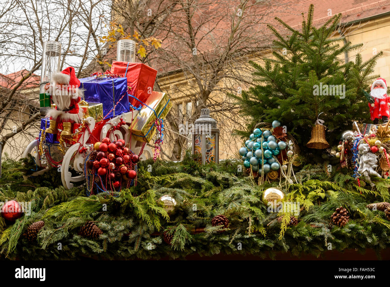 gift boxes, glass balls and a Santa puppet between spruce branches on ...