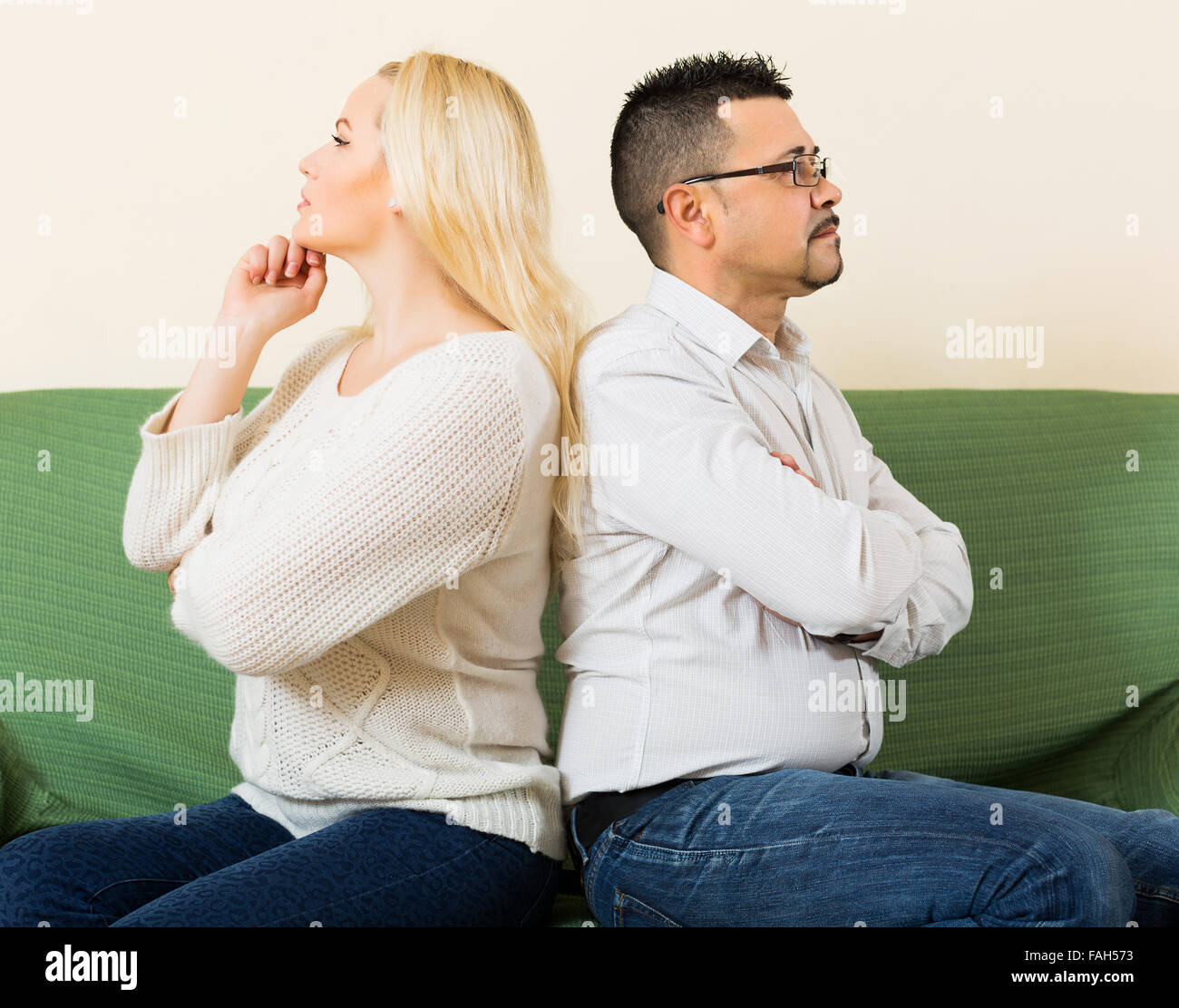 Sad married couple after quarrel at home Stock Photo - Alamy