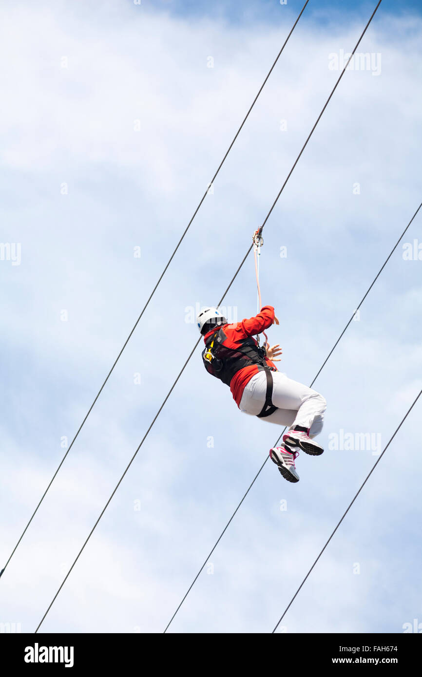 Visitors enjoy the pier zip wire ride to the beach at Bournemouth beach ...