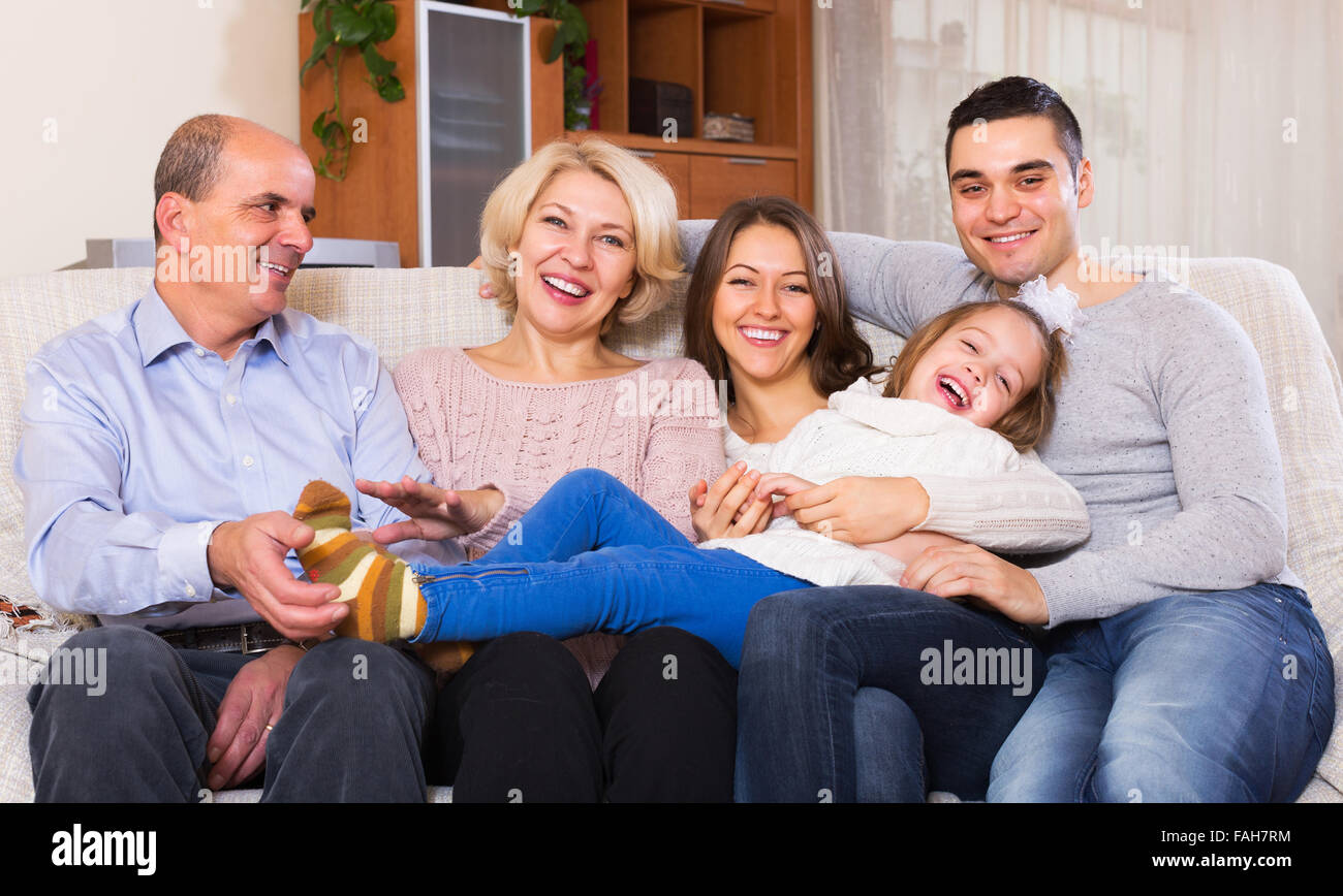 Smiling big united family members together in living room Stock Photo ...