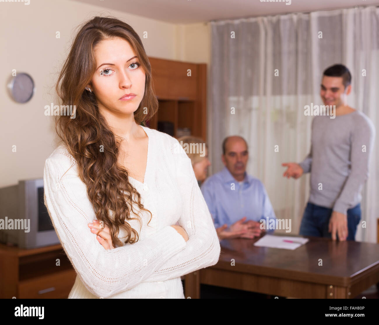 Sad girl faced with misunderstanding big european family Stock Photo ...