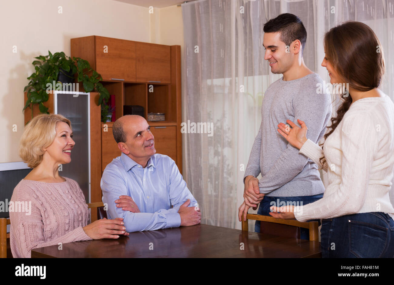 happy parents meeting girlfriend of their son at home Stock Photo - Alamy