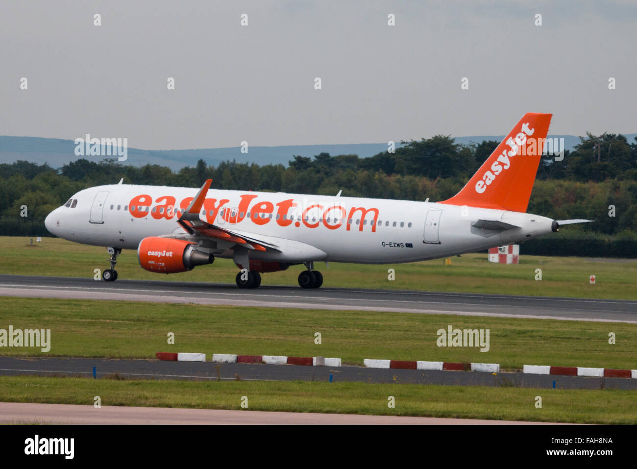 easyJet Airbus A320-214 taxing along the runway at Manchester airpot ...