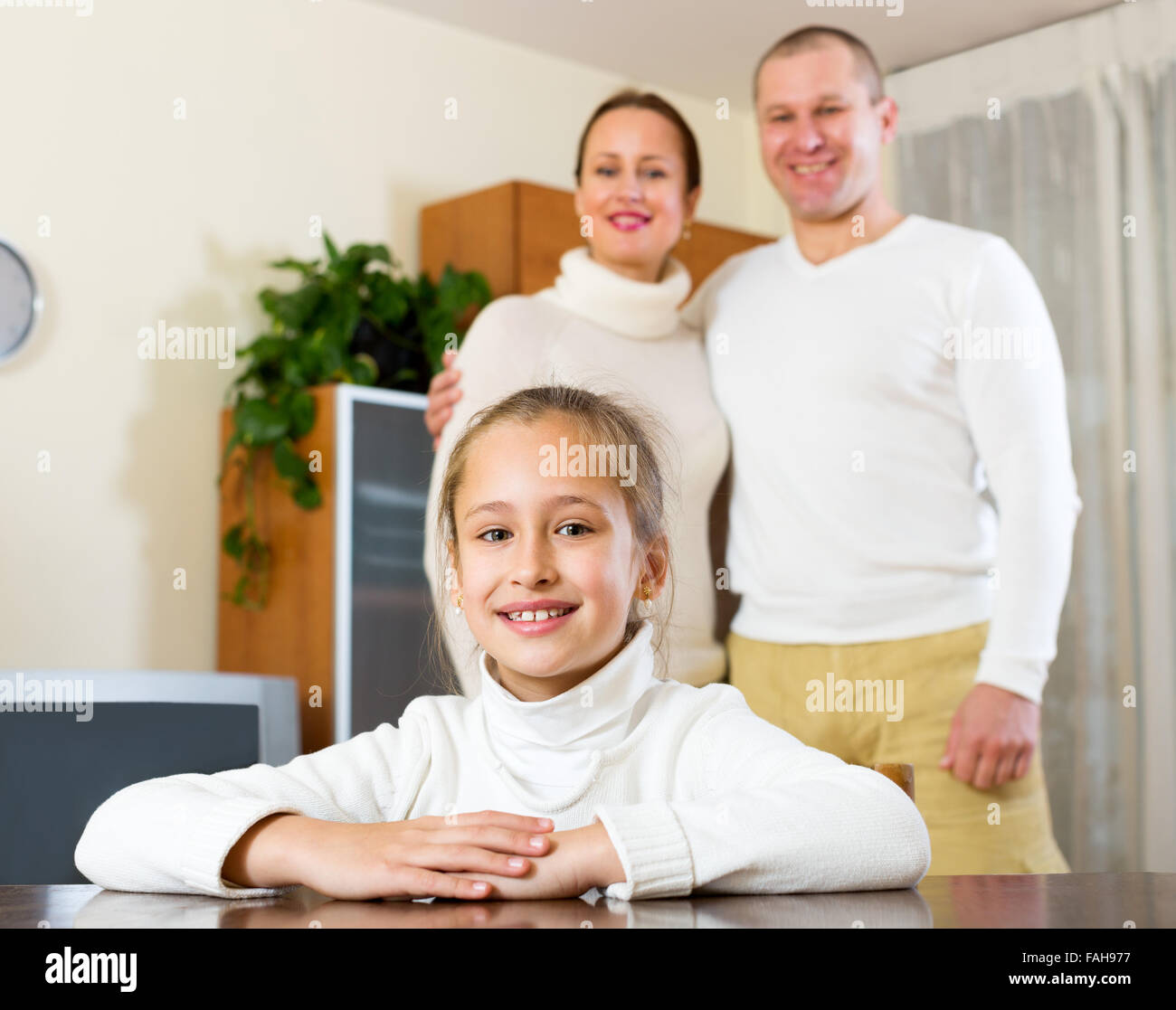 Smiling parents and their small child relaxing at home Stock Photo - Alamy