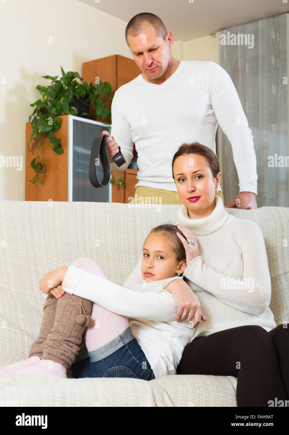 Litlle daughter comforting sad mother at home and angry father Stock ...