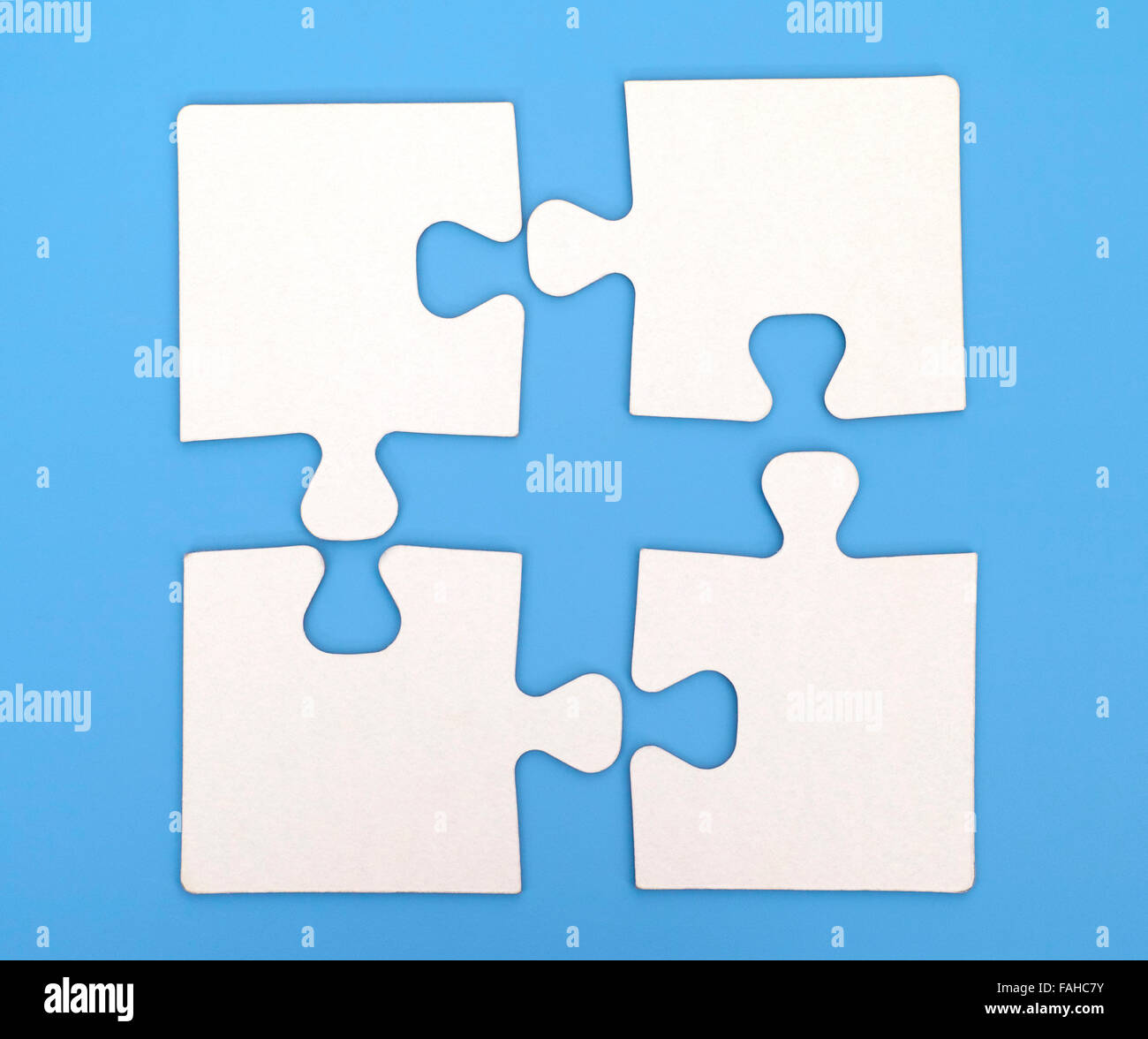 Simple puzzle on blue background Stock Photo - Alamy