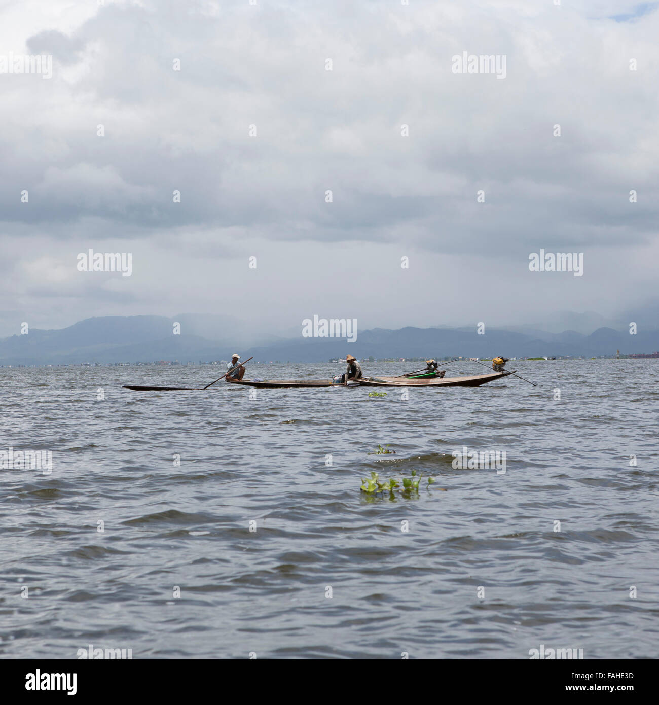 Intha fishermen on Inle Lake in Myanmar (Burma). The men are leg rowers ...