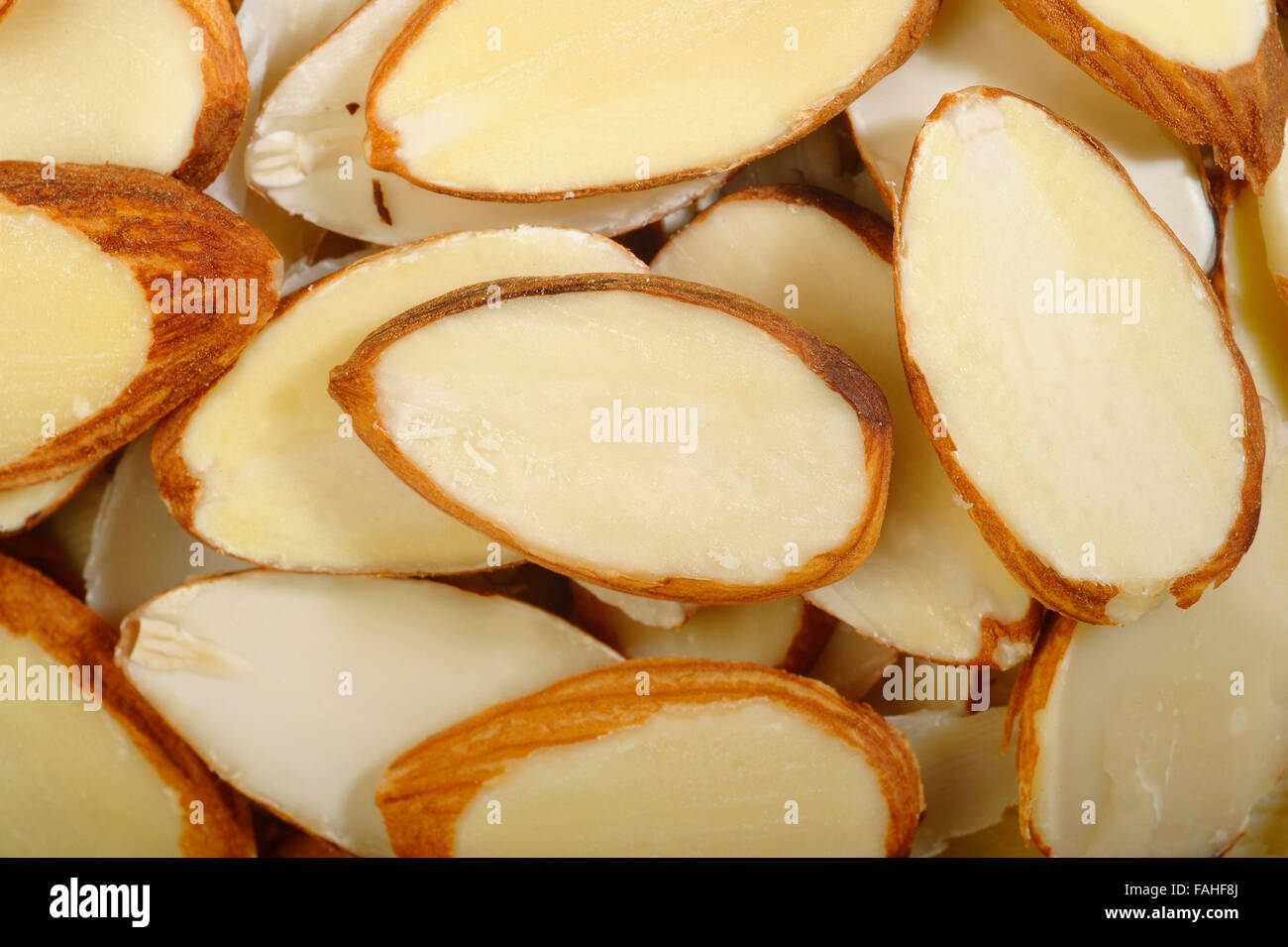 sliced raw almonds background Stock Photo - Alamy