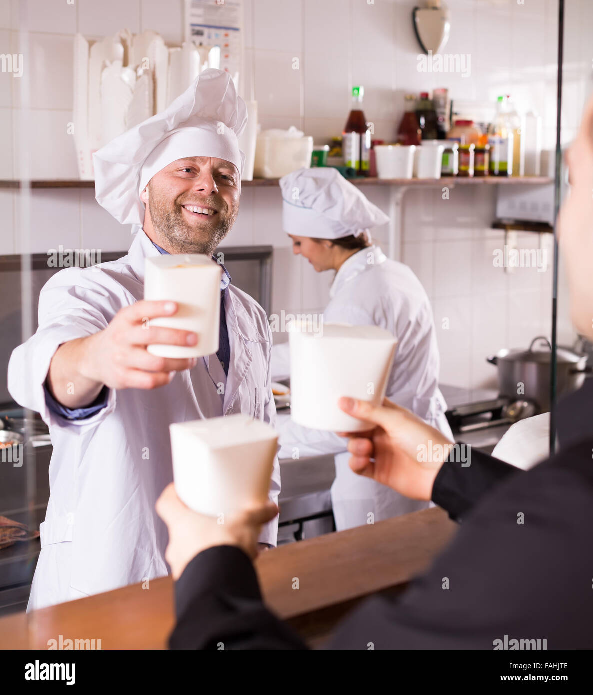 Young guy purchasing fast food in cardboard box at cafe Stock Photo - Alamy