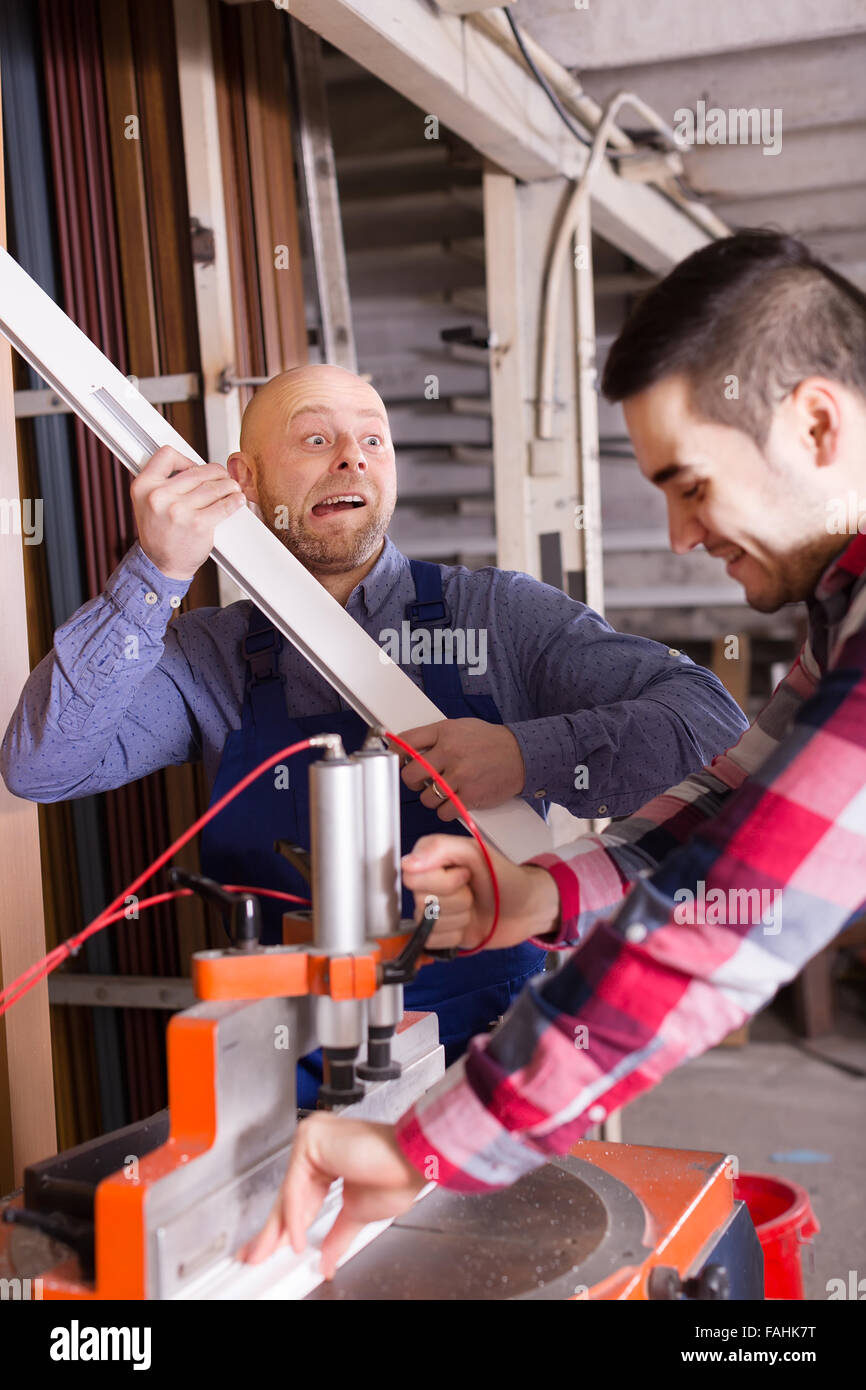 Couple of american workers near milling machine at factory Stock Photo ...