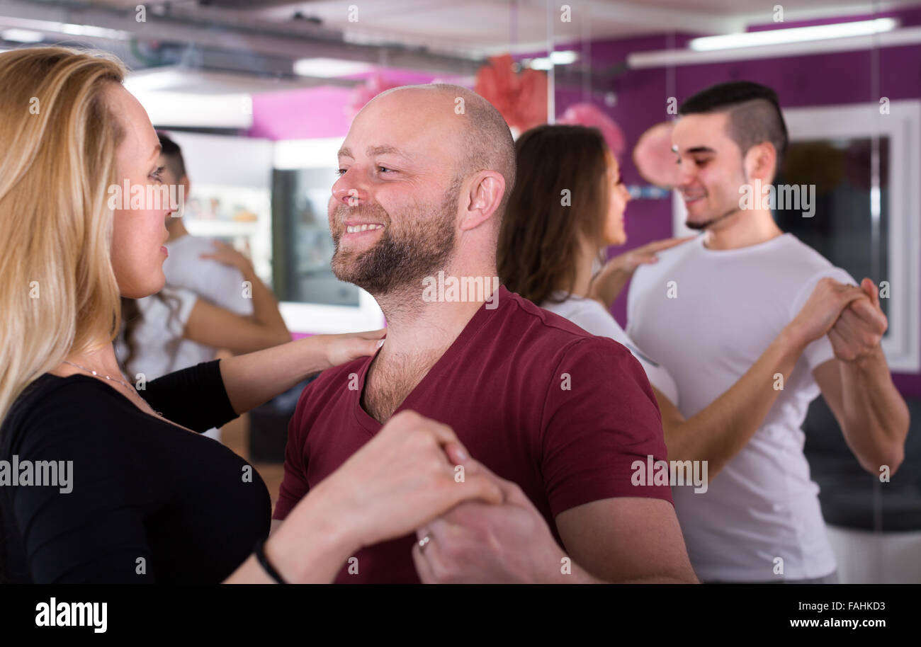 Happy smiling people having dancing class indoors Stock Photo - Alamy