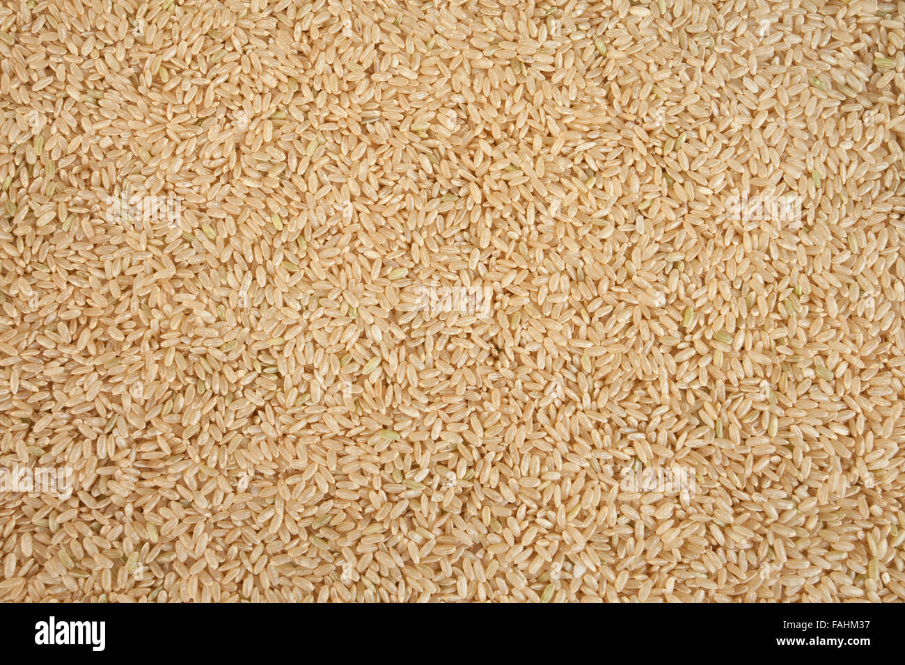 Integral uncooked brown rice texture Stock Photo - Alamy