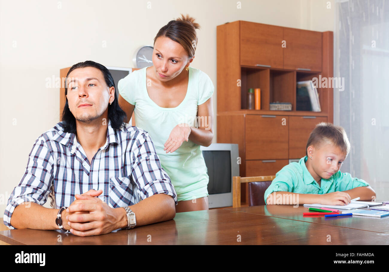 Family of three after quarrel in home Stock Photo - Alamy