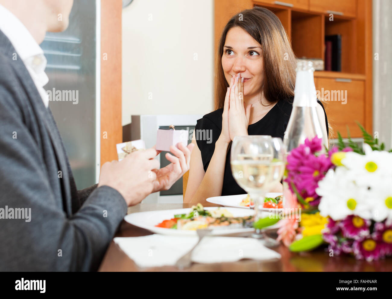 Marriage proposal. Man presenting to amazed woman engagement ring at ...