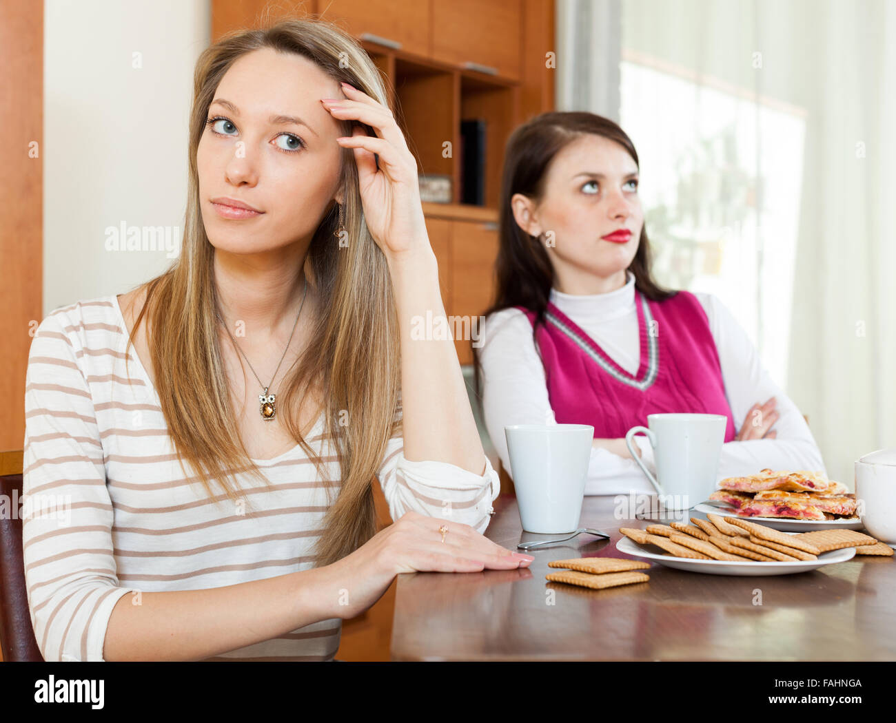 women after conflict at table in home Stock Photo - Alamy
