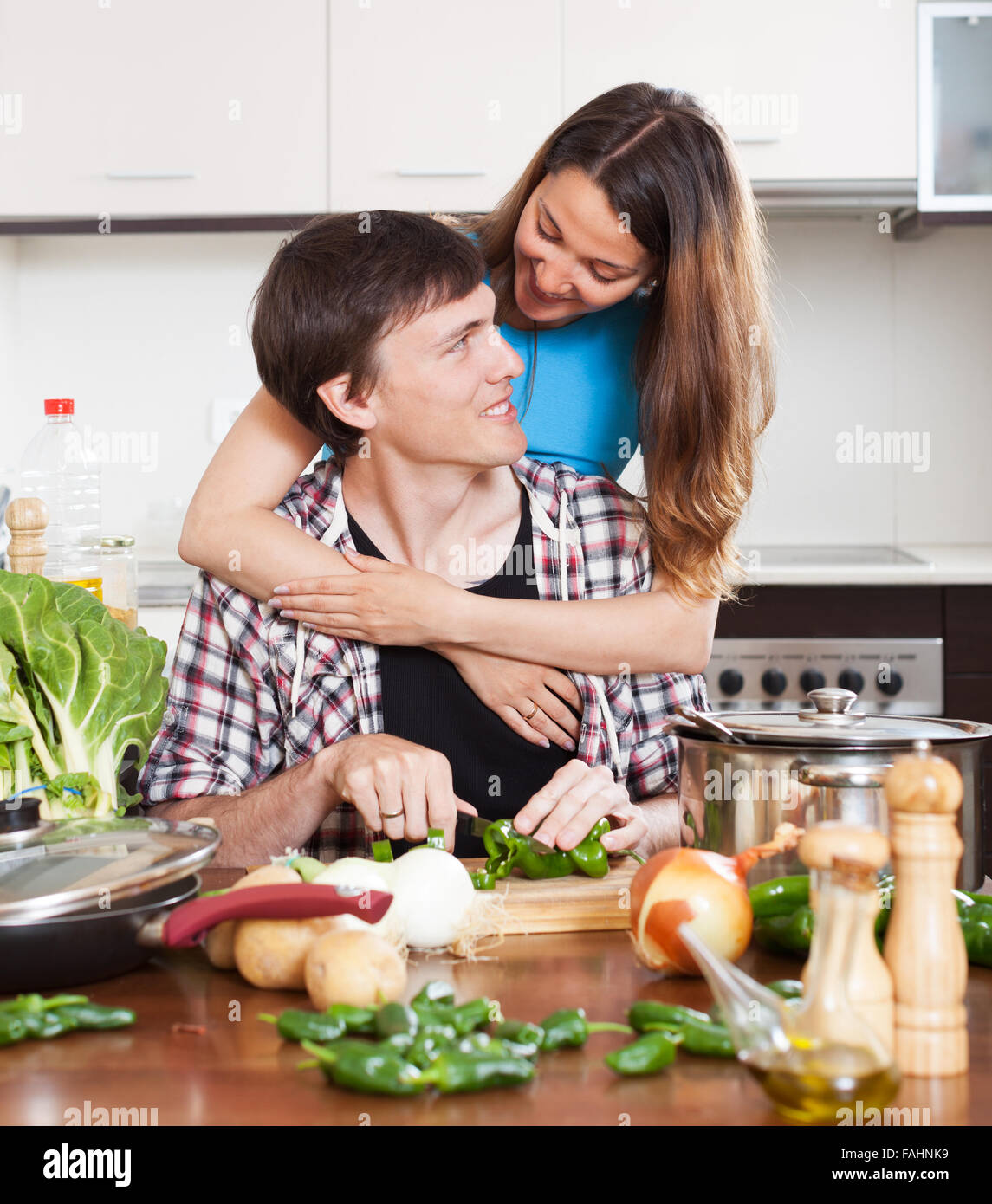 Happy loving couple cooking together in home kitchen Stock Photo - Alamy
